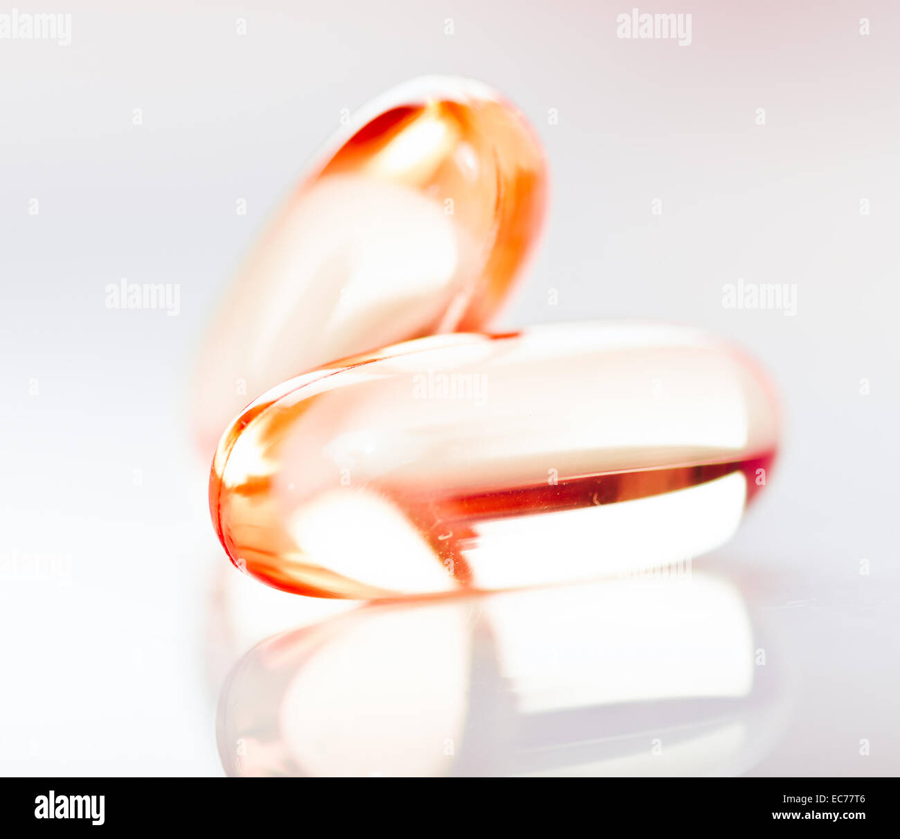 shiny yellow vitamin e fish oil capsule on white background Stock Photo ...