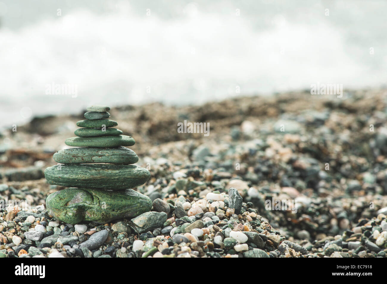 Stacked green sea stones Stock Photo - Alamy