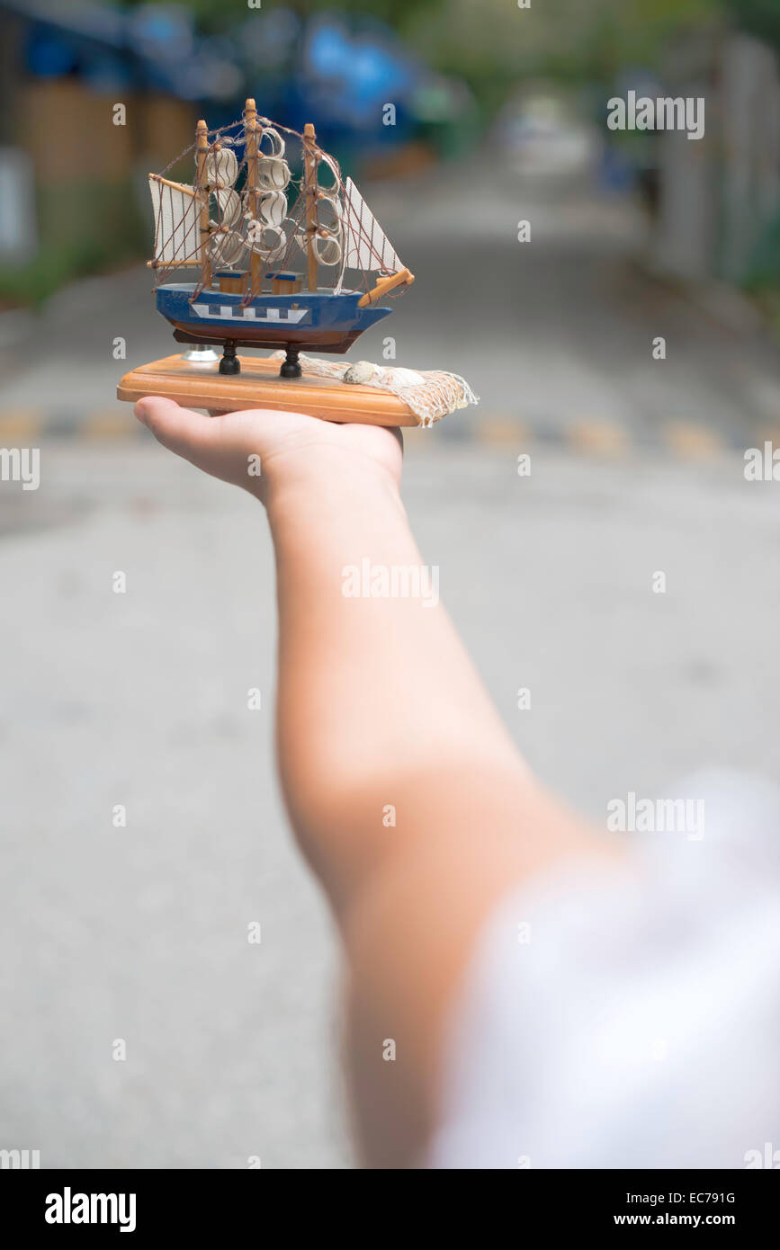 Hand holding model of a sailing ship Stock Photo - Alamy