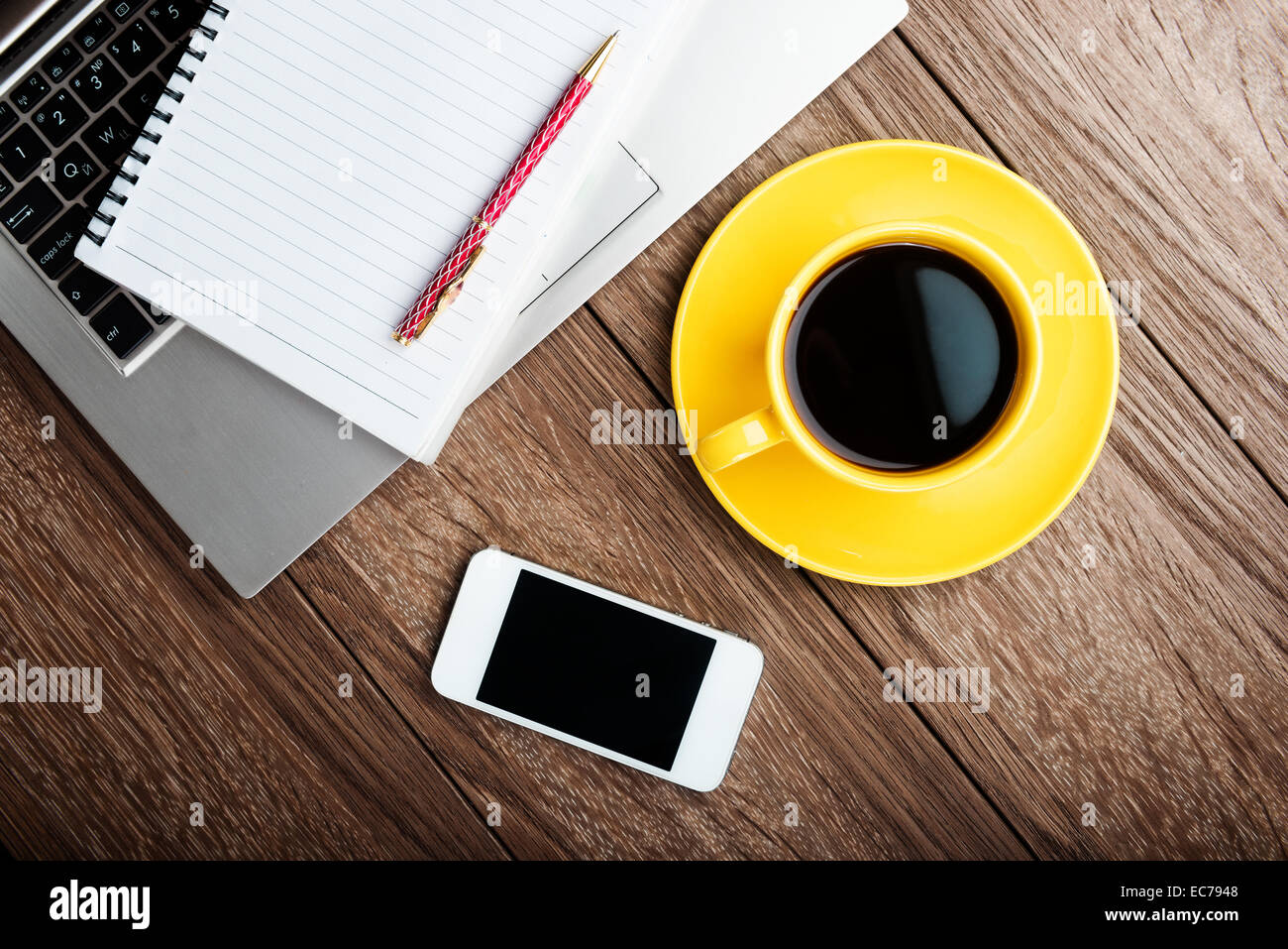 Office desk with laptop computer, notebook, mobile smartphone and ...