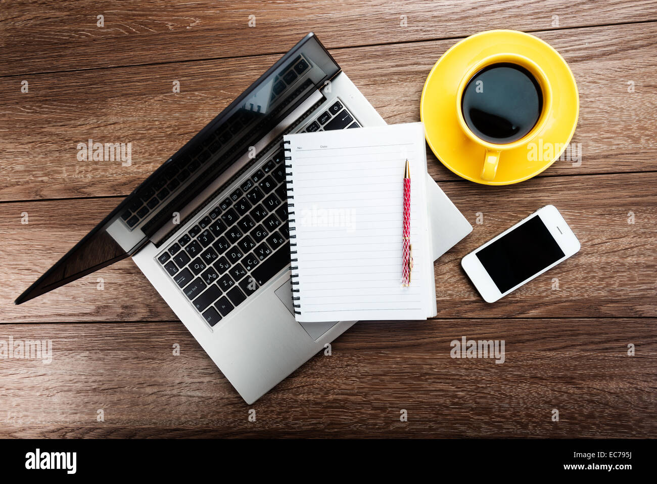 Office desk with laptop computer, notebook, mobile smartphone and ...