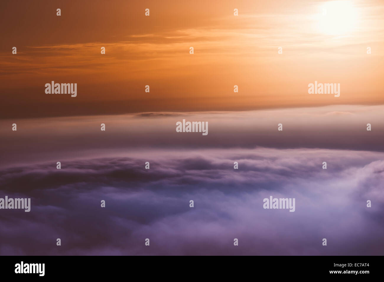 Sunset over the clouds Stock Photo - Alamy