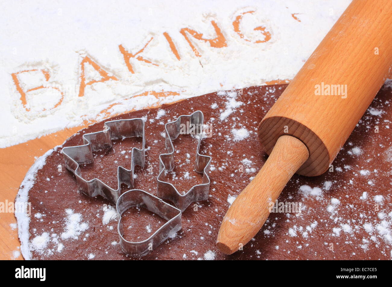 Word baking written in white flour, dough for gingerbread and ...
