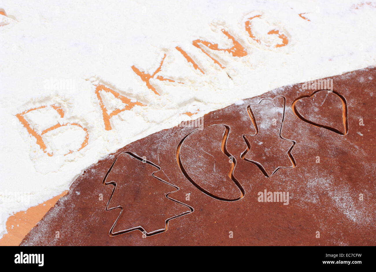Word baking written in white flour and shape of cookie cutters, concept ...