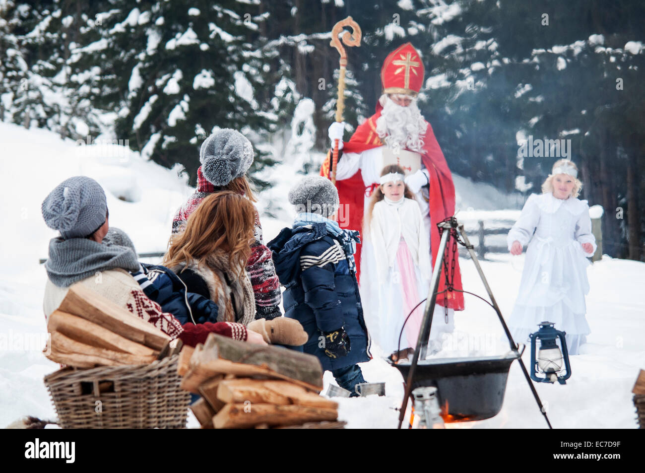Family looking at angels and Santa Claus in snow Stock Photo - Alamy