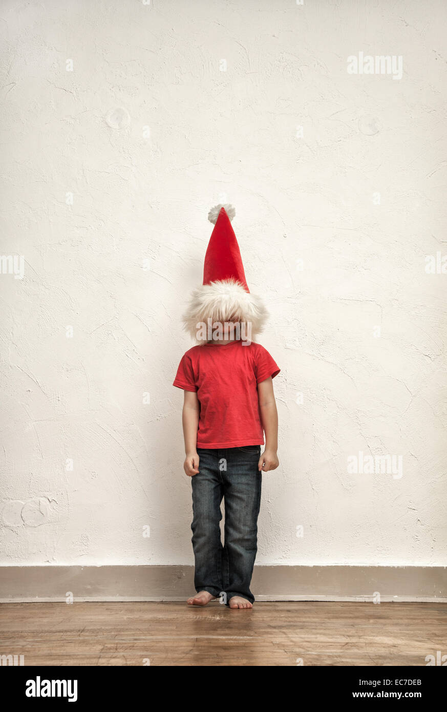 Little boy's face hiding under oversized Christmas cap Stock Photo - Alamy