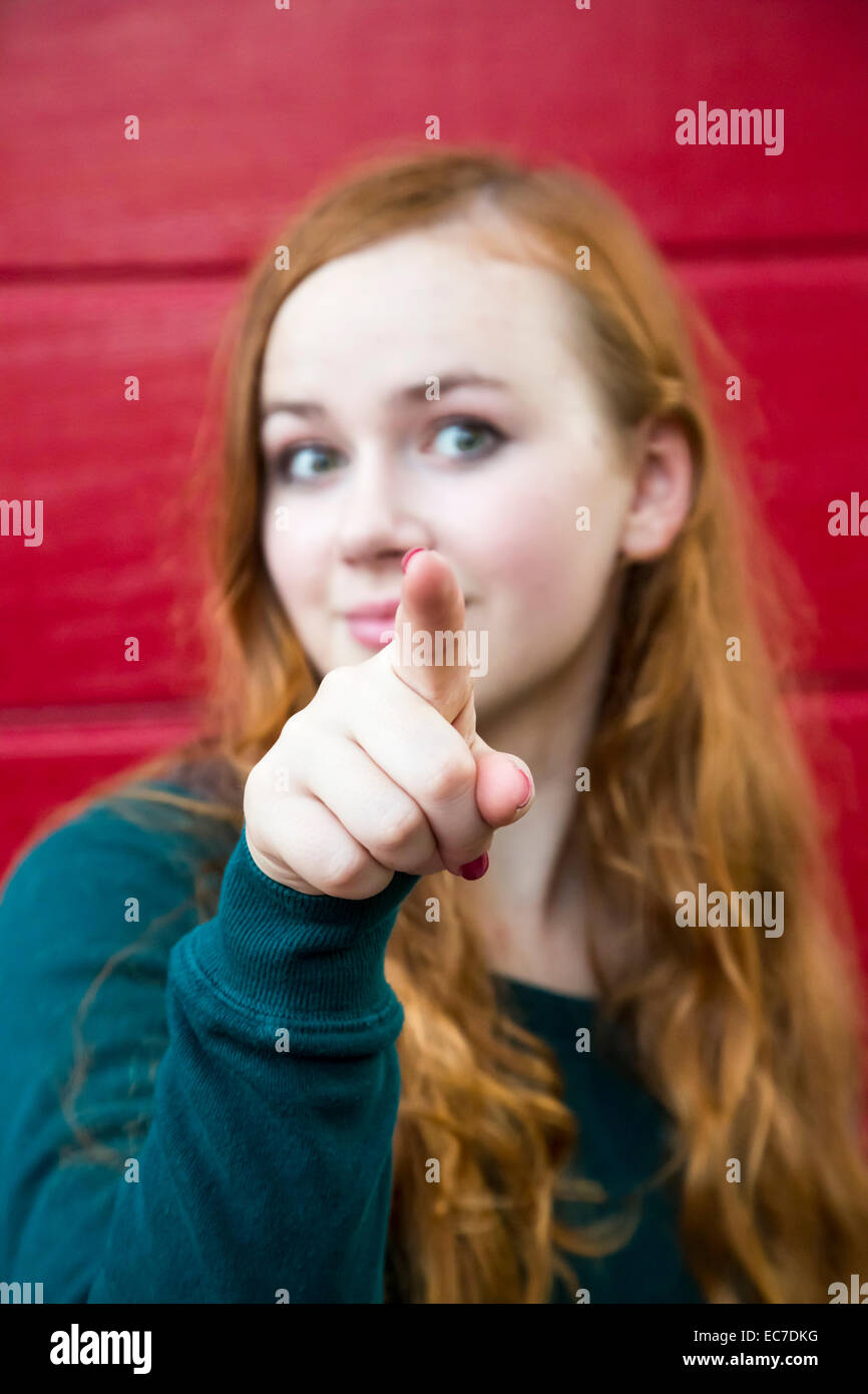 Teenage girl pointing on viewer Stock Photo - Alamy