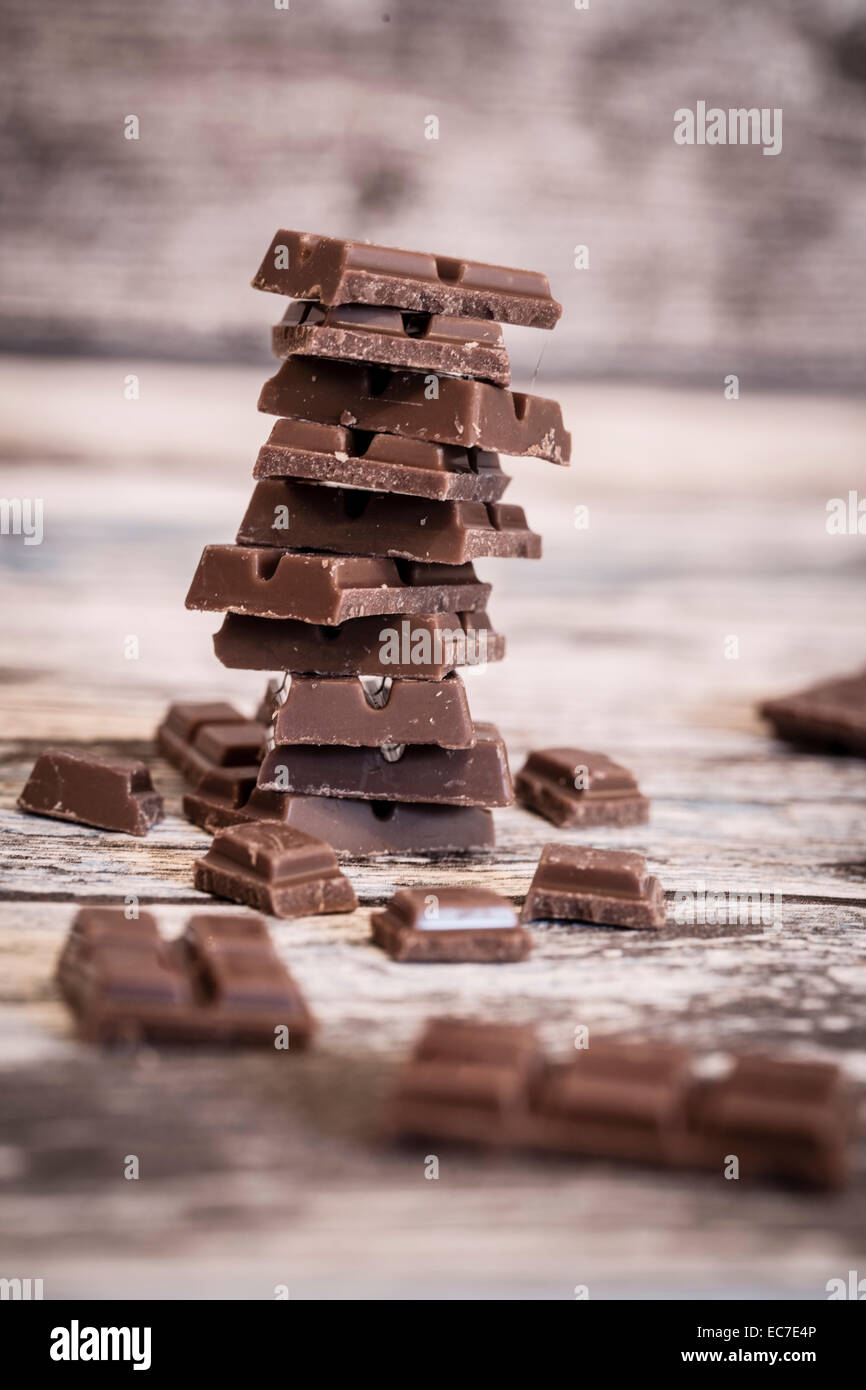 Stack of chocolate pieces on wood Stock Photo - Alamy