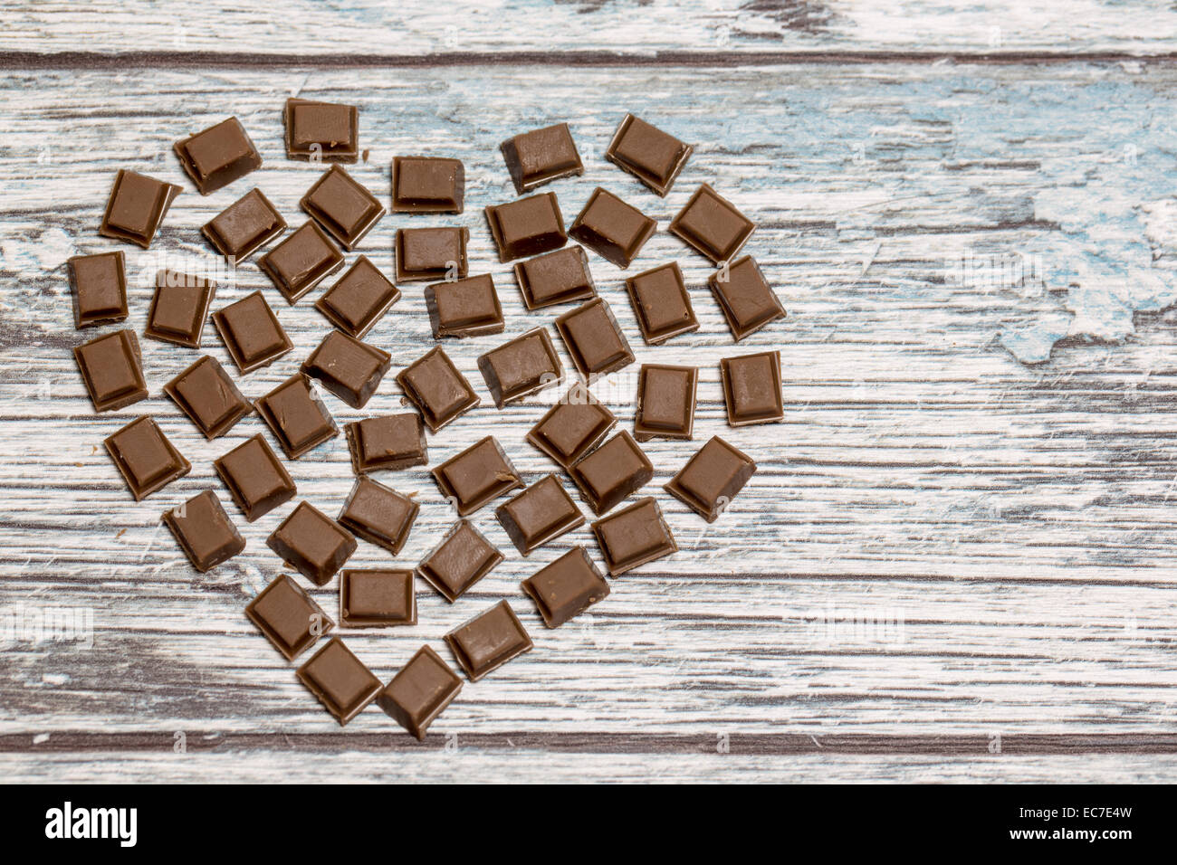 Heart formed by pieces of chocolate on wood Stock Photo - Alamy