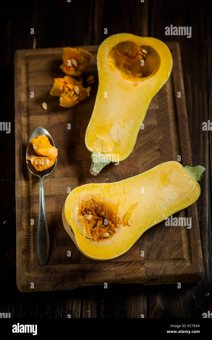 Deseeding a butternut squash, Cucurbita moschata, with a spoon Stock ...