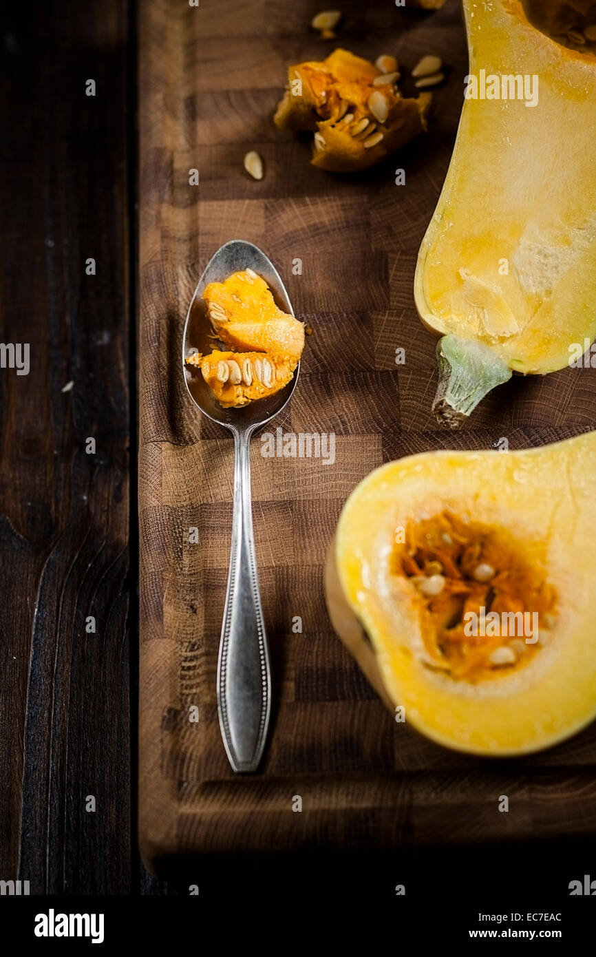 Deseeding a butternut squash, Cucurbita moschata, with a spoon Stock ...