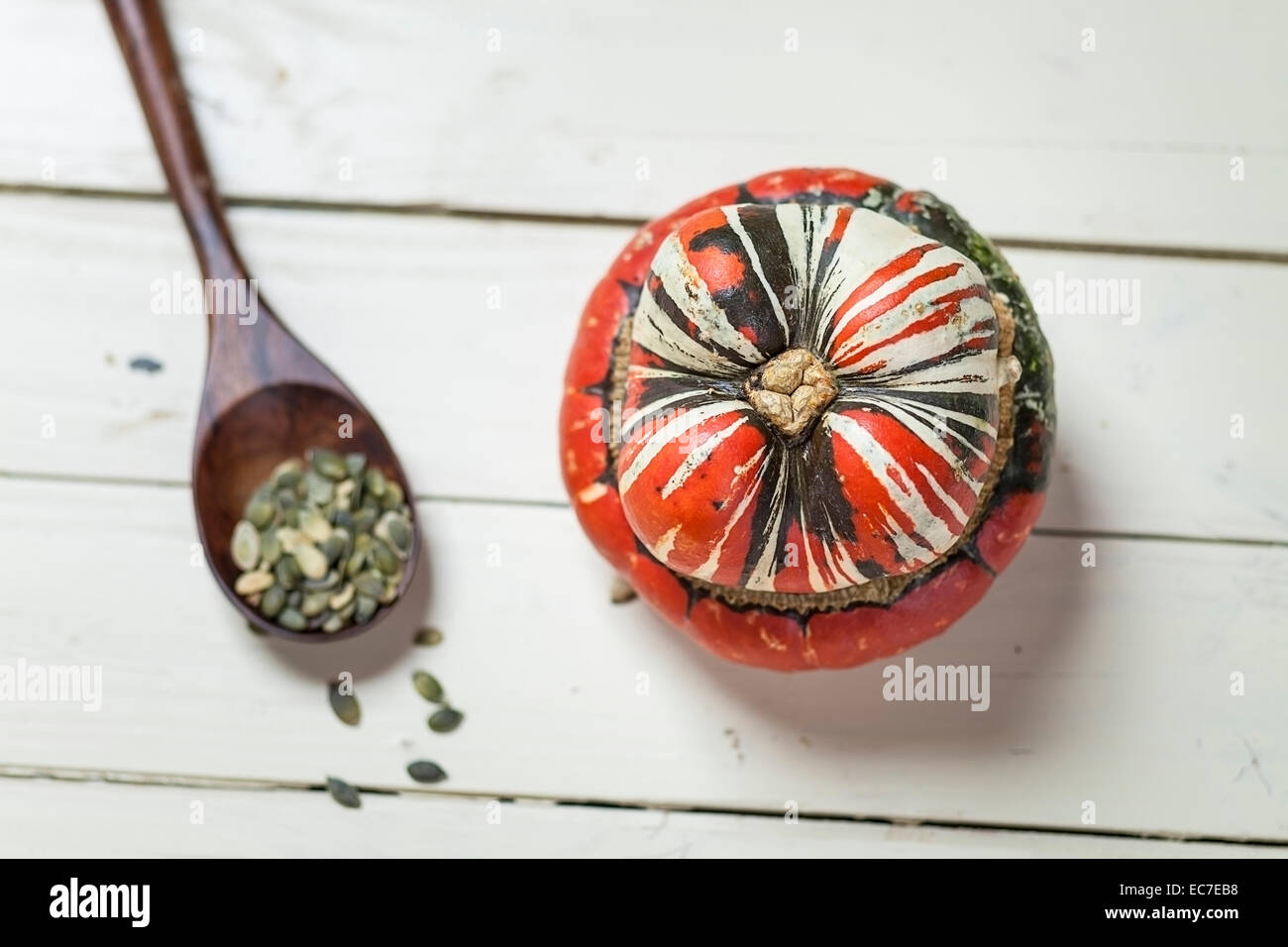 Turban squash and wooden spoon with pumpkin seeds on white wood Stock ...