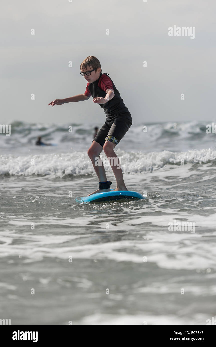 Boy learning surfboarding Stock Photo - Alamy