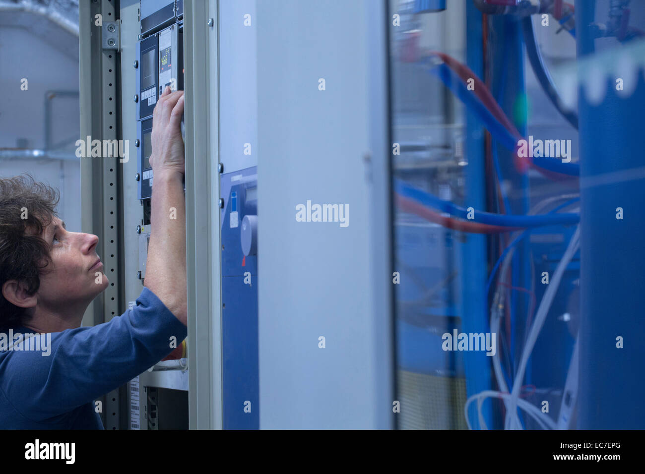 Female technical support specialist reducing the heat of a machine in a ...