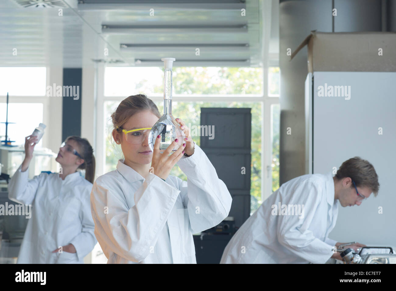 Three chemists working in a chemical laboratory Stock Photo - Alamy