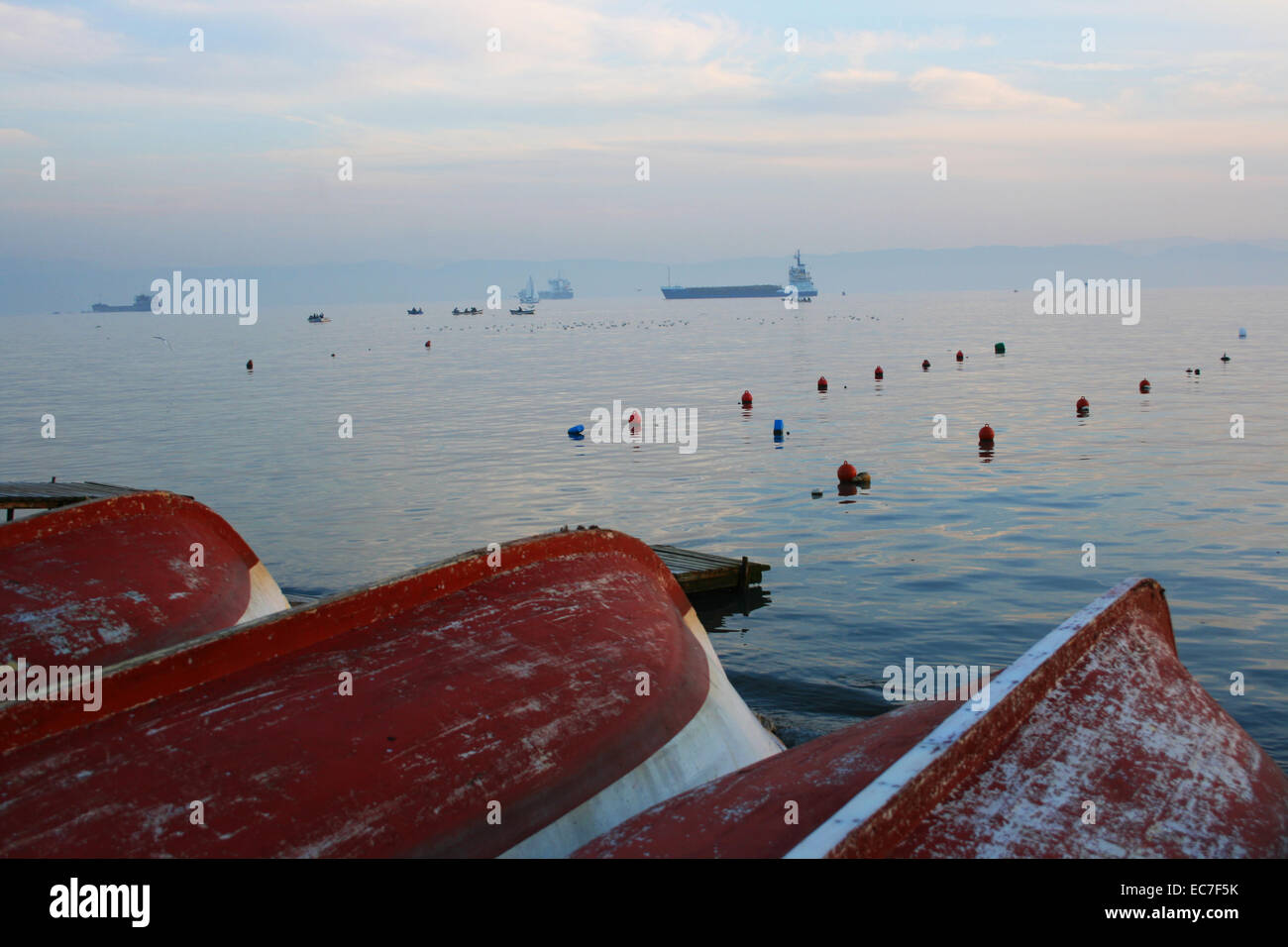 Red boats against blue water Stock Photo - Alamy