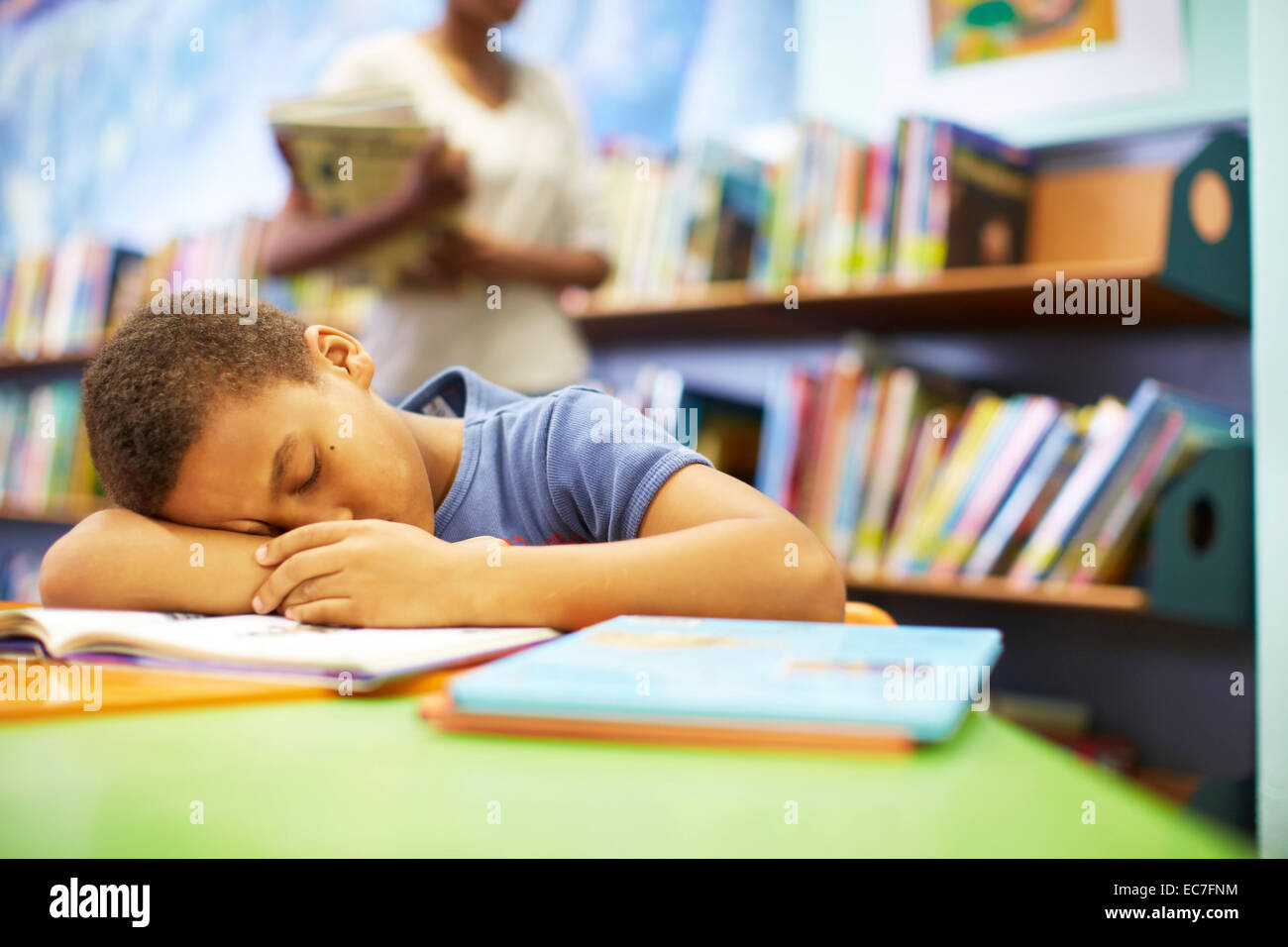 Sleeping boy in library Stock Photo - Alamy
