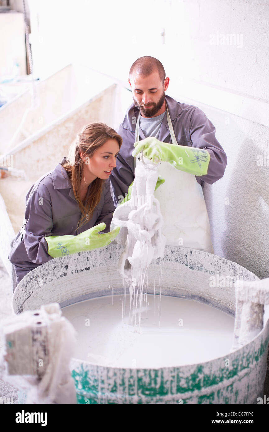 South Africa, Cape Town, Craftspeople preparing ceramic shell around ...