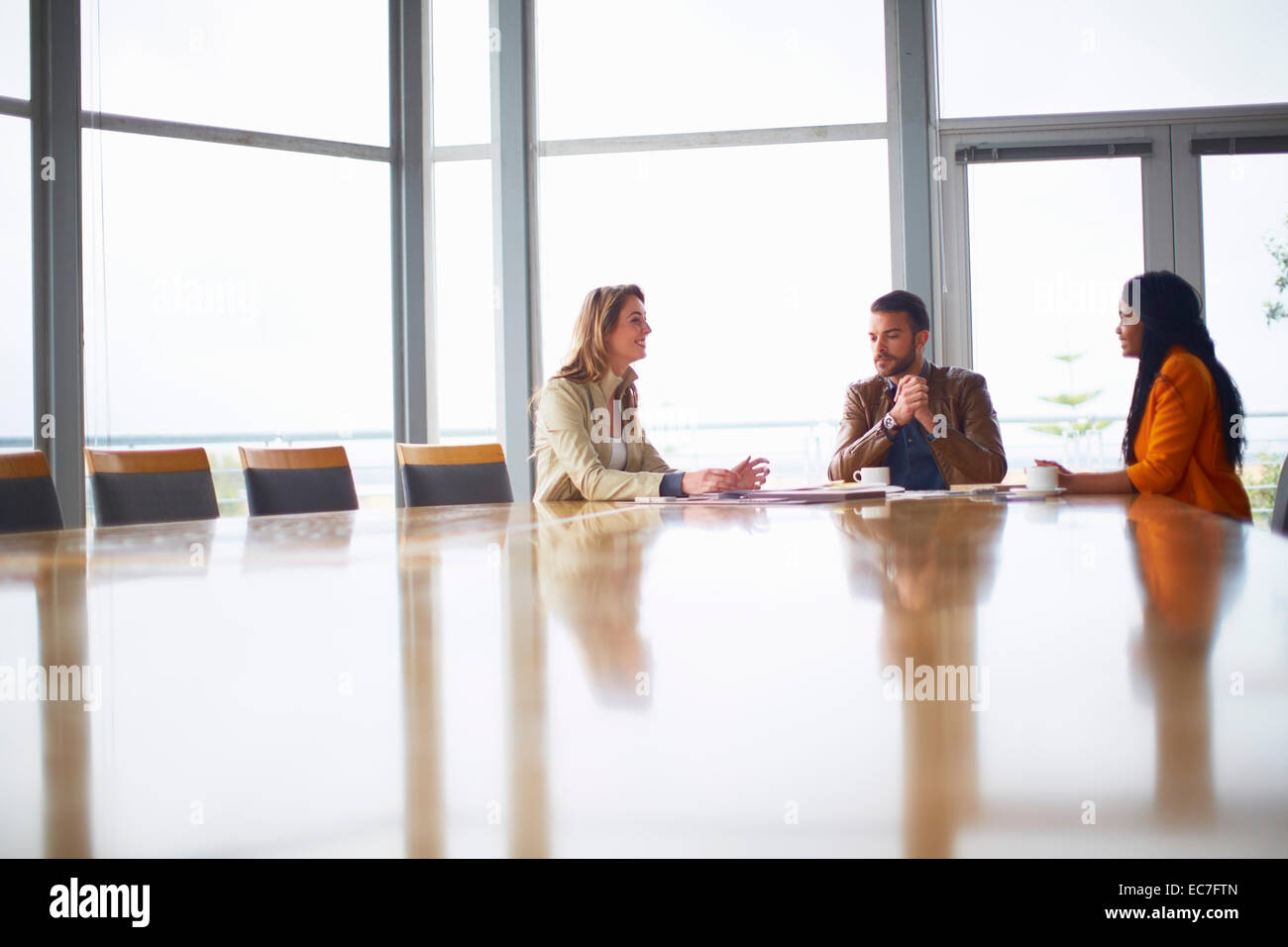 Three people at business meeting Stock Photo - Alamy