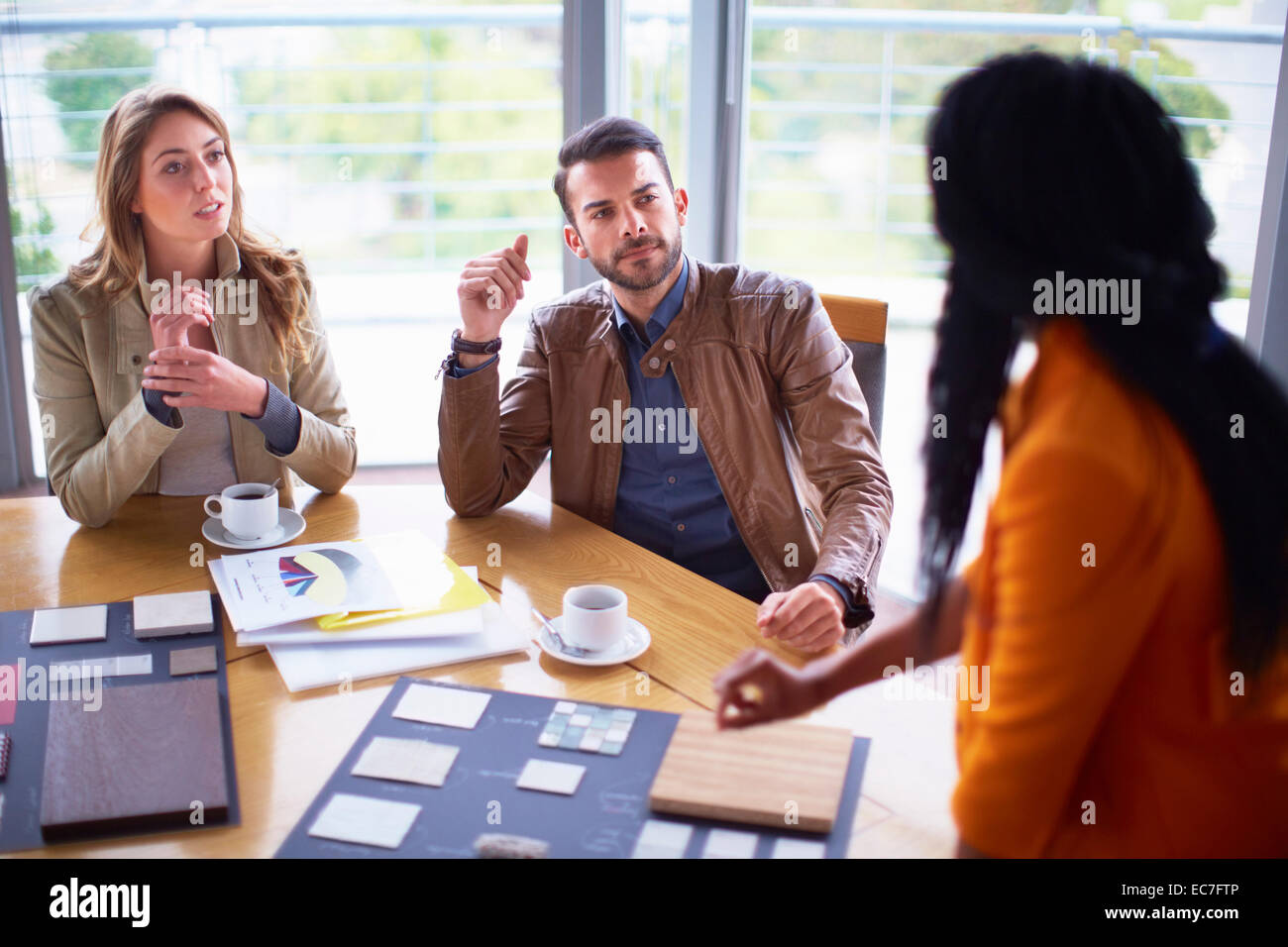 Three people at business meeting Stock Photo - Alamy