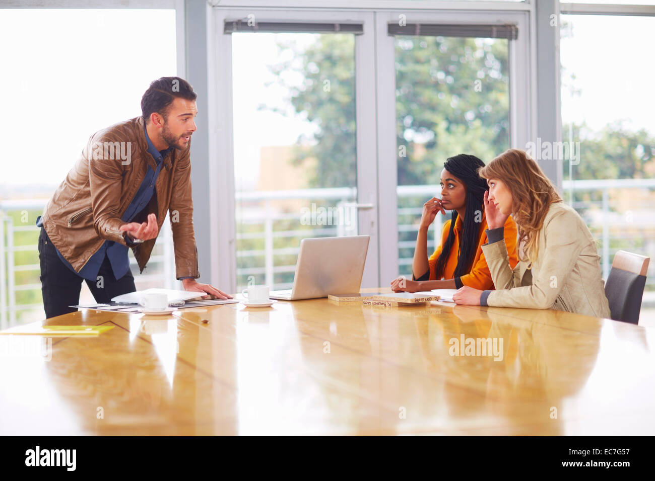 Three people at business meeting Stock Photo - Alamy