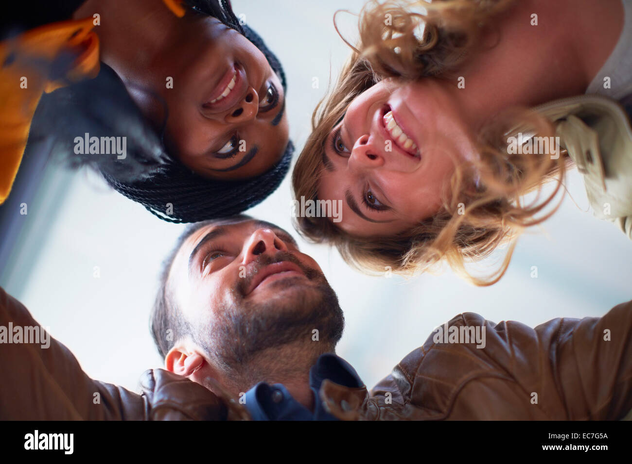 Portrait of three creative people, view from below Stock Photo - Alamy