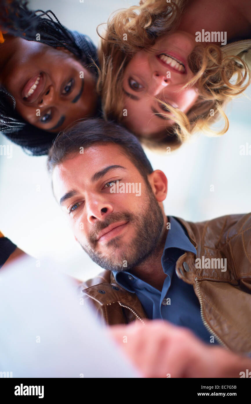 Portrait of three creative people, view from below Stock Photo - Alamy