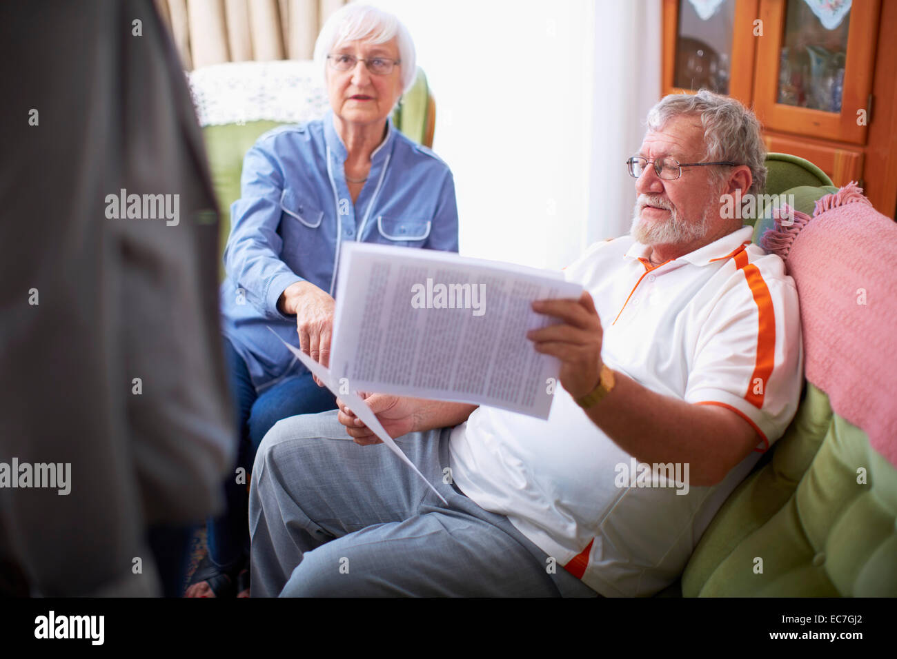 Senior couple reading document Stock Photo - Alamy
