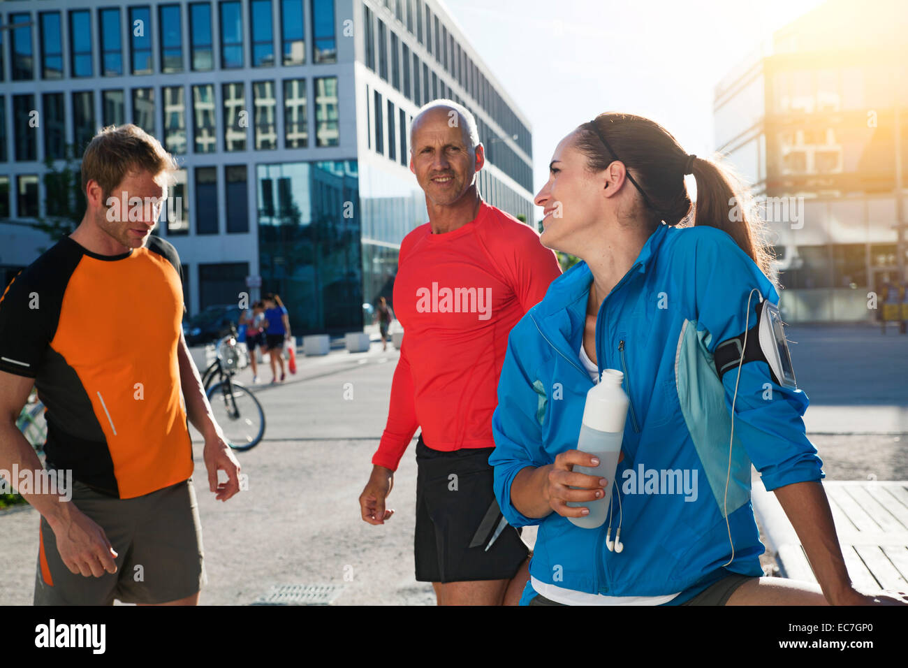Three athletic people outdoors Stock Photo - Alamy