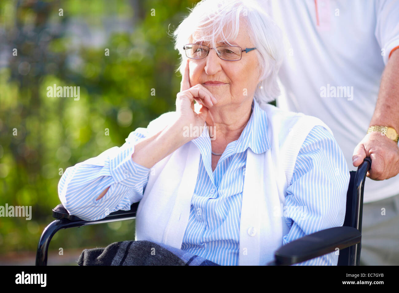 Man pushing senior woman in wheelchair Stock Photo - Alamy