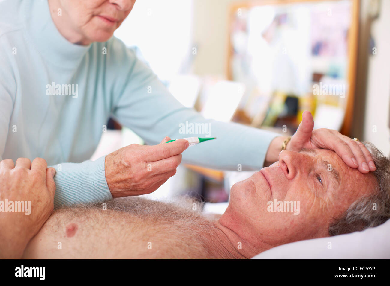 Woman taking husband temperature hi-res stock photography and images ...