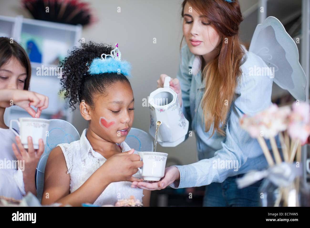 Girls and teenage girl on a tea party Stock Photo - Alamy