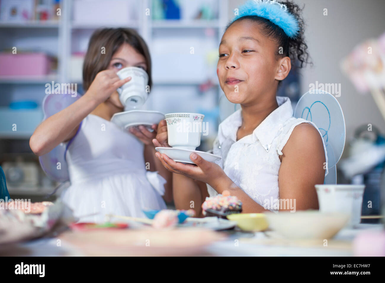 Two girls on a tea party Stock Photo - Alamy