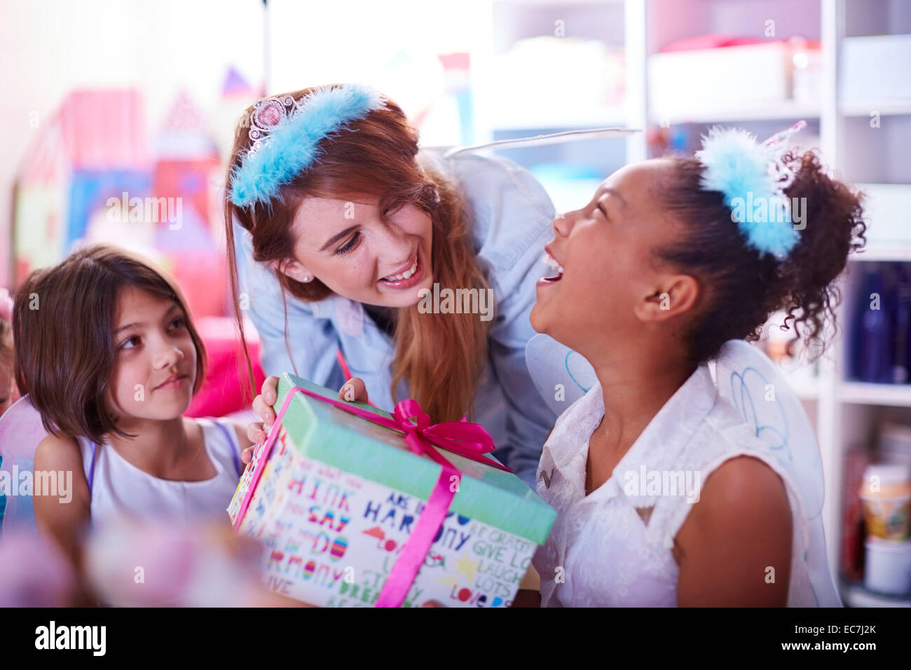 Girl receiving gift on a birthday party Stock Photo - Alamy