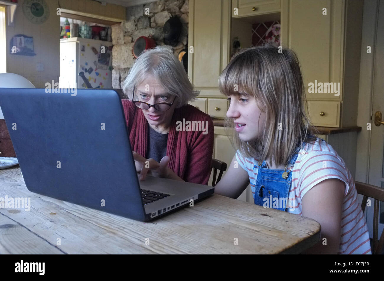 An 11 Year Old Girl Teaches Her Grandmother How To Use A Computer Stock