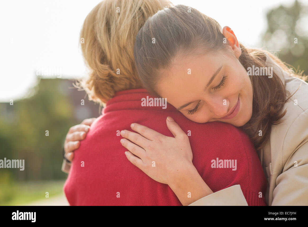 Granddaughter and her grandmother caressing each other Stock Photo - Alamy