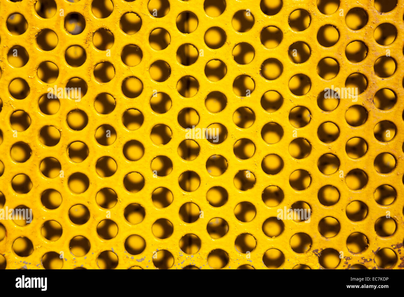 Part of yellow perforated board Stock Photo - Alamy
