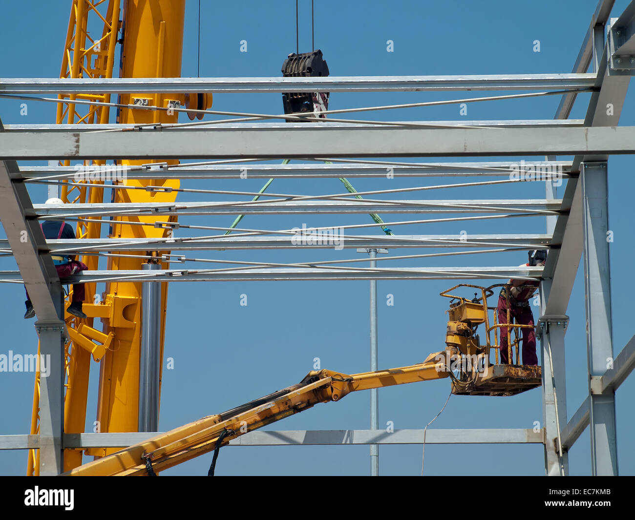 workers assembling construction frames on industrial hall Stock Photo ...
