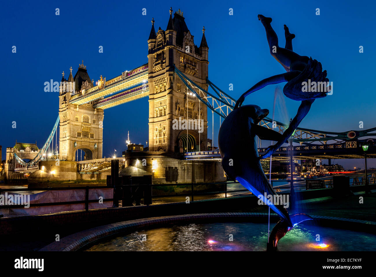 Girl With A Dolphin Fountain and Tower Bridge, London, England Stock ...