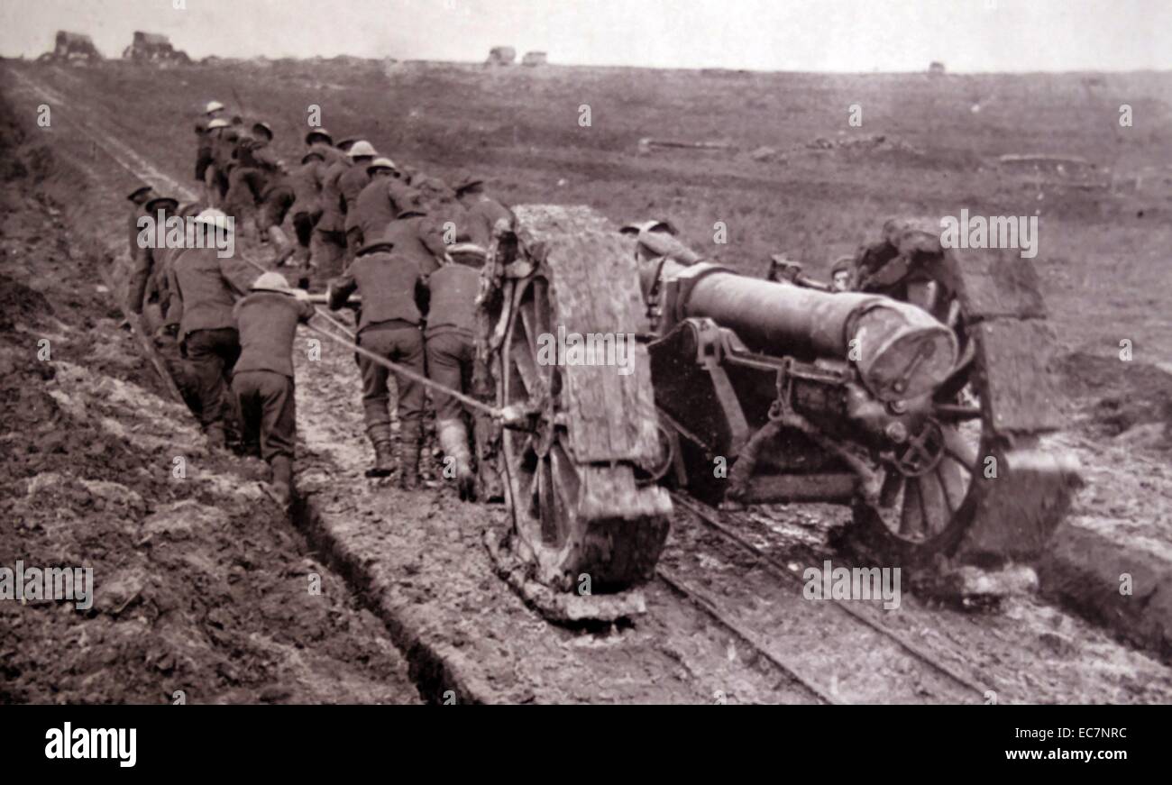 British soldiers drag a large artillery cannon through a battlefield in ...