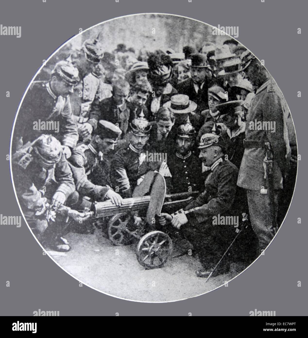 German soldiers and civilians examine a Russian artillery gun captured ...