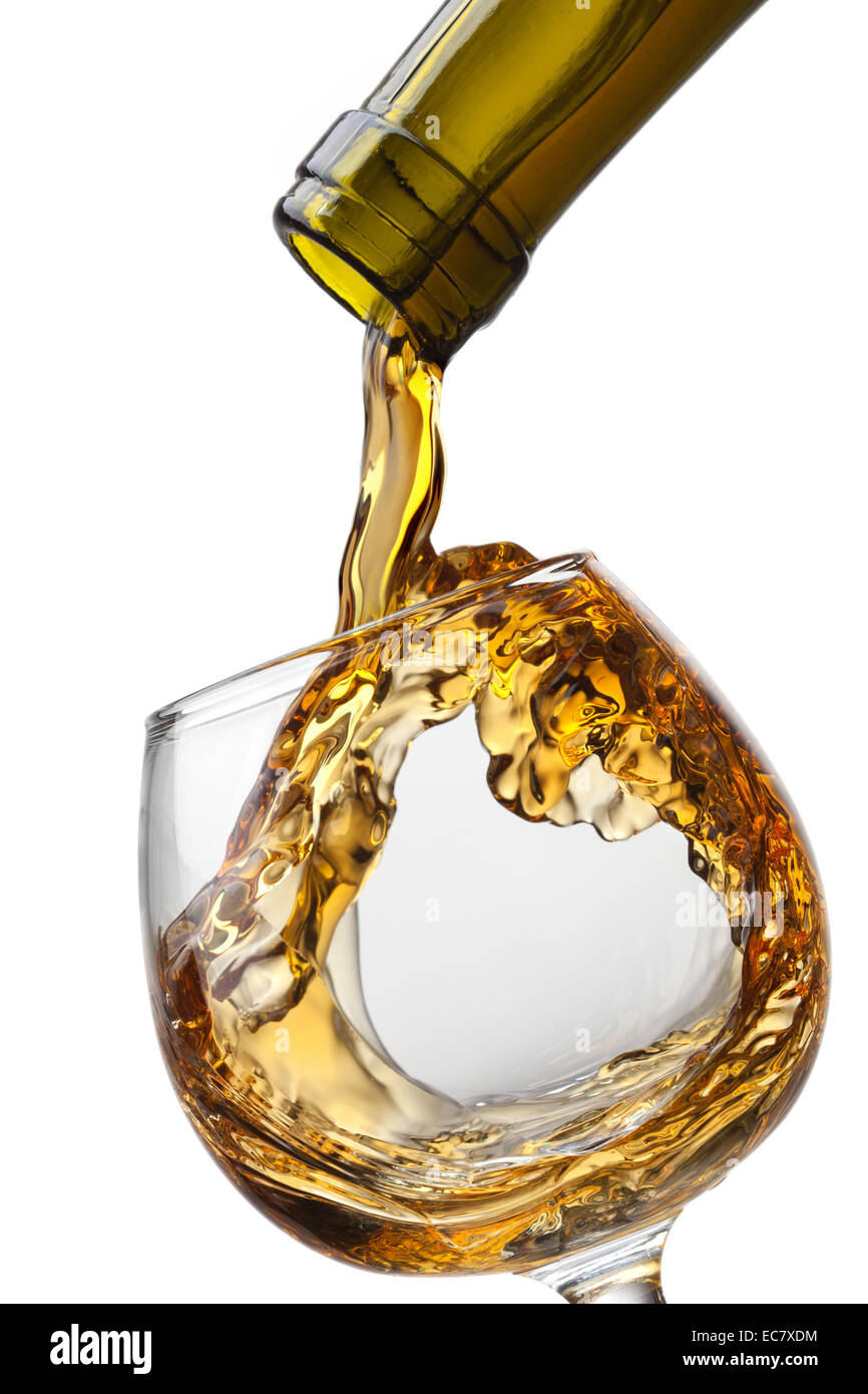 Cognac pouring into glass with splash isolated on white background ...
