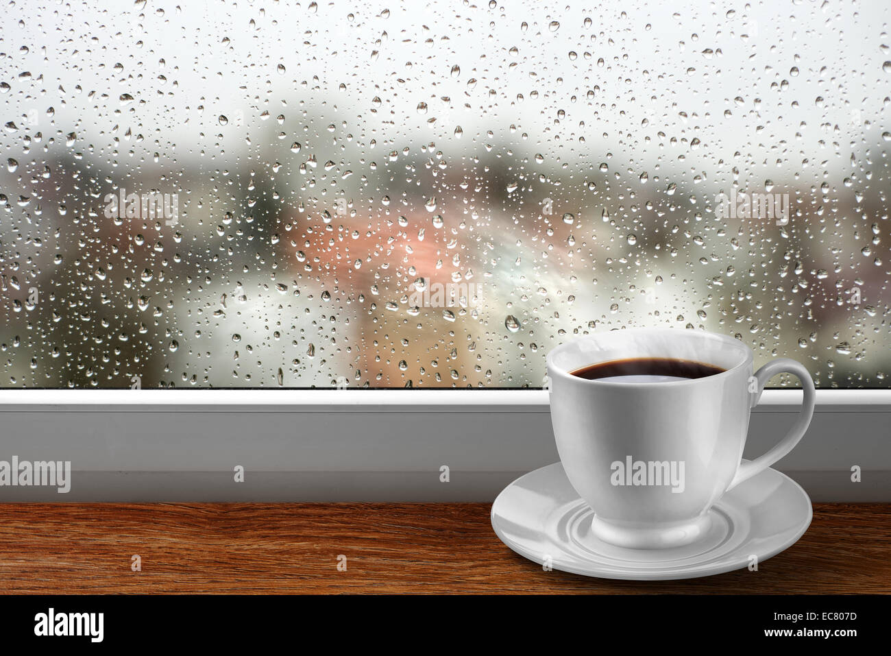 Coffee cup against window with rainy day view Stock Photo - Alamy