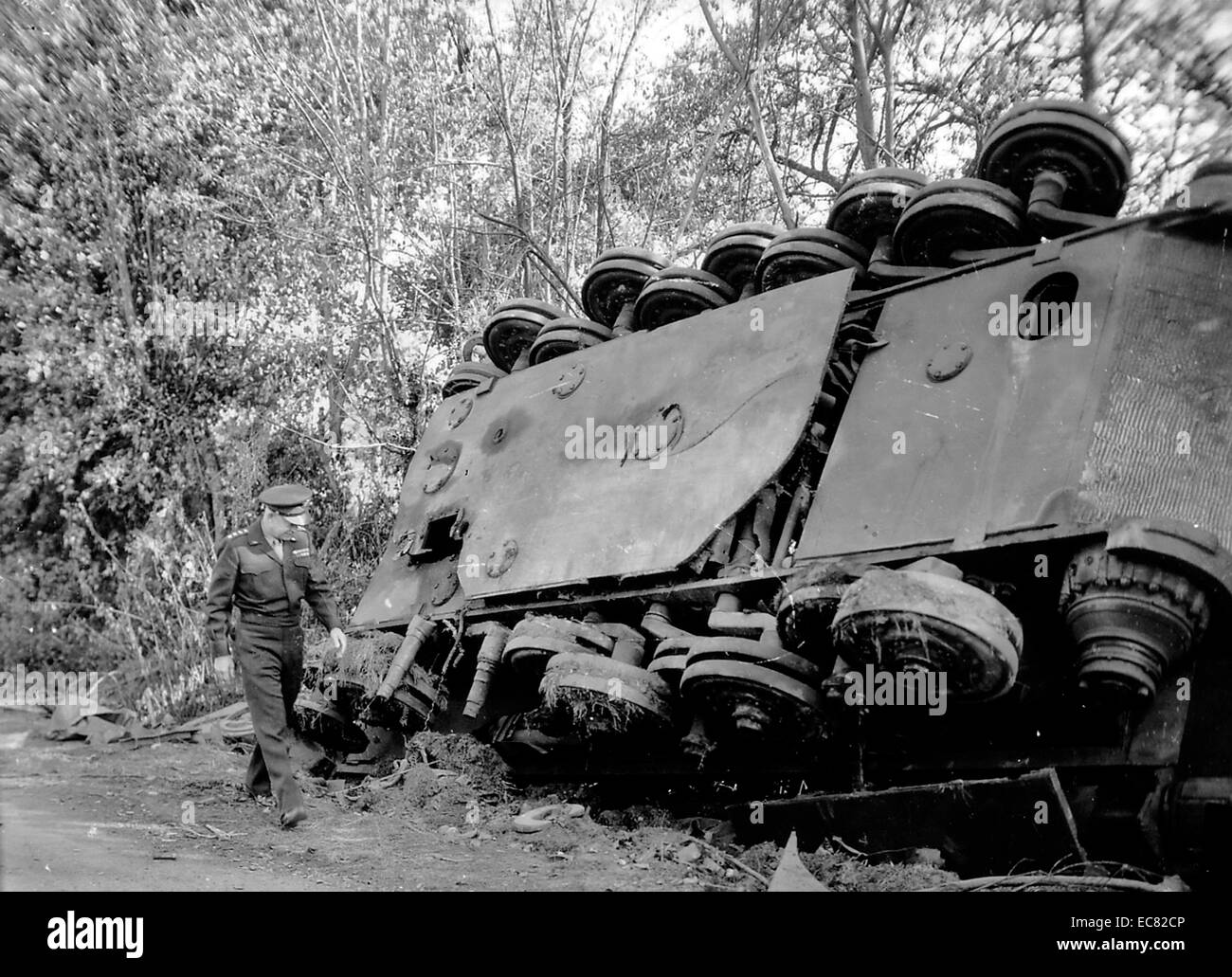 General Eisenhower walks past a destroyed overturned German tank, 1945 ...