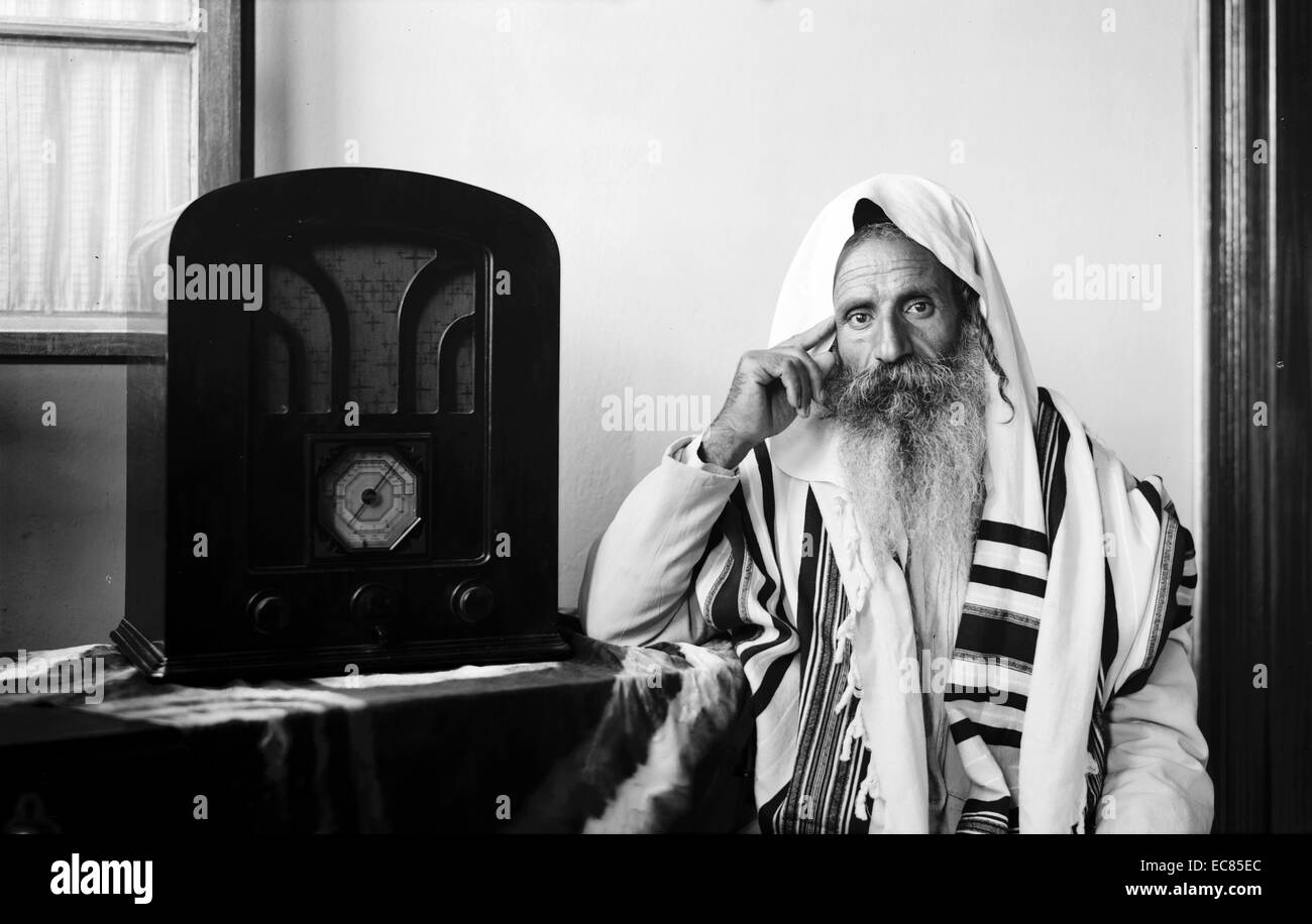 Photograph of a Yemeni Jew listening to a radio in Jerusalem. Dated ...