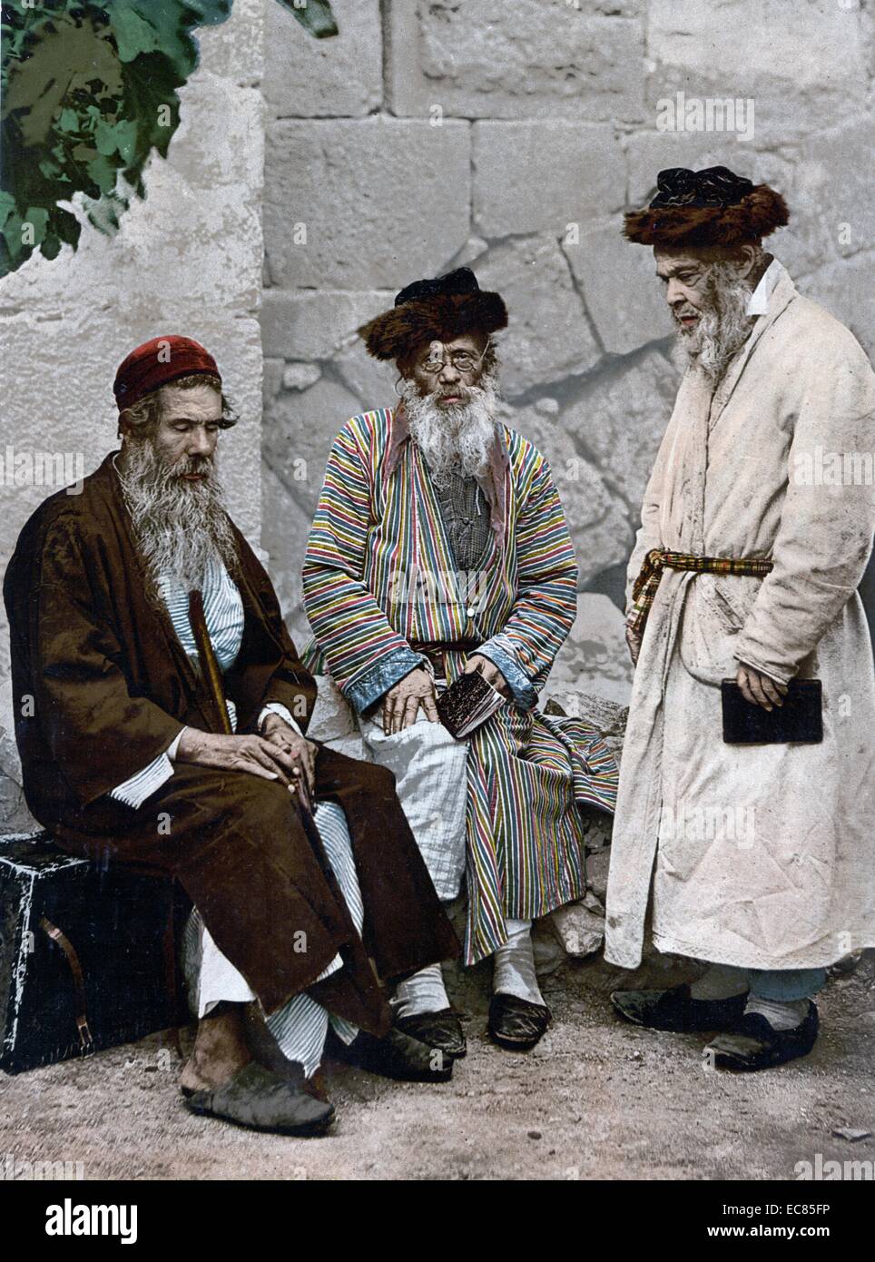 Colour photograph of Orthodox Jewish men sitting Jerusalem during the ...