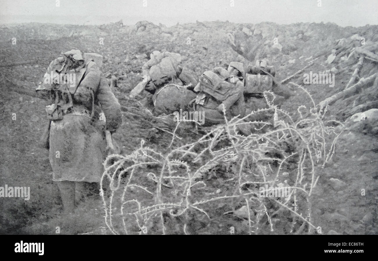 Photograph of French troops under fire move through a trench. Dated ...