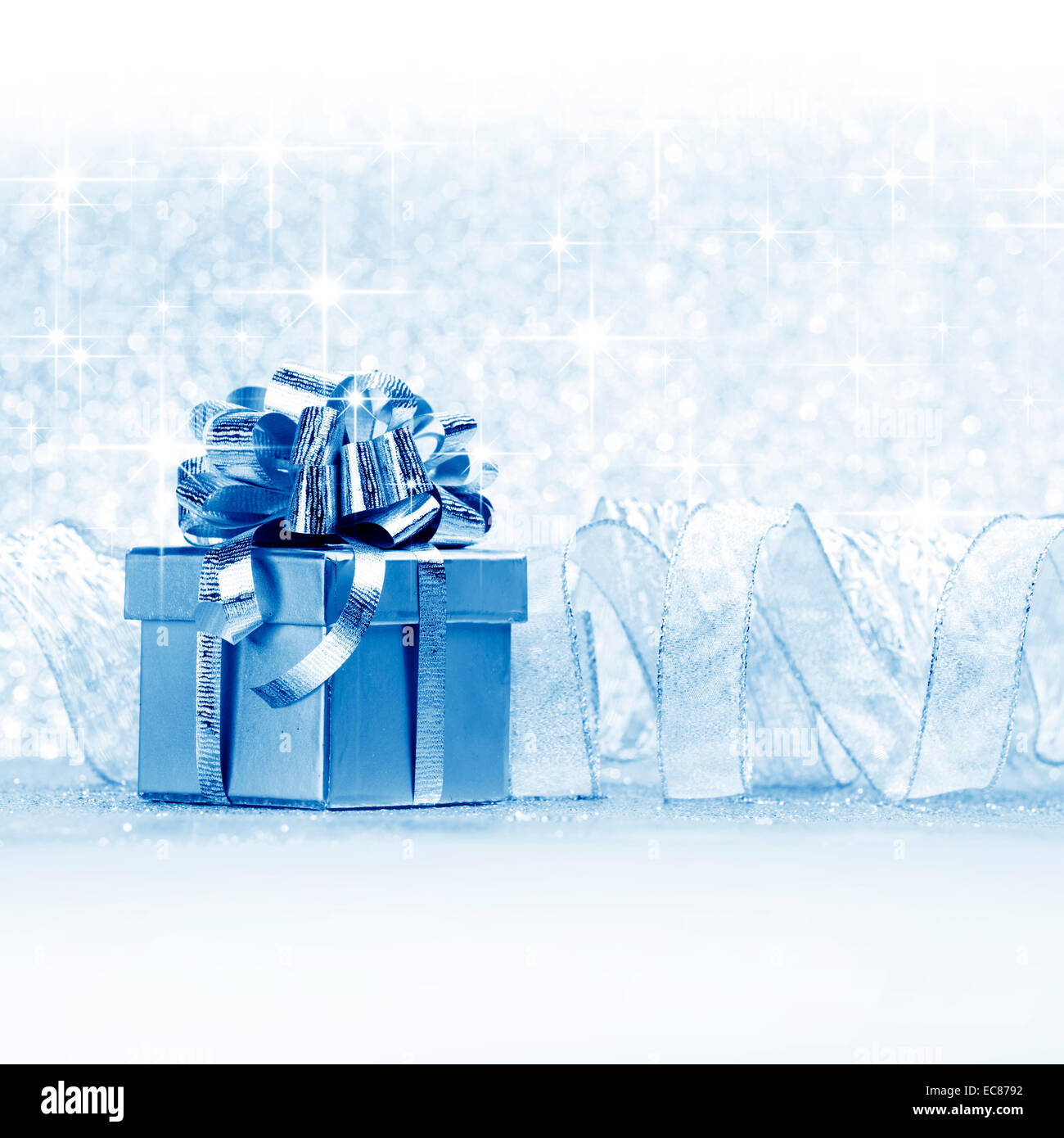Blue christmas gift on glitter shiny background with stars Stock Photo ...