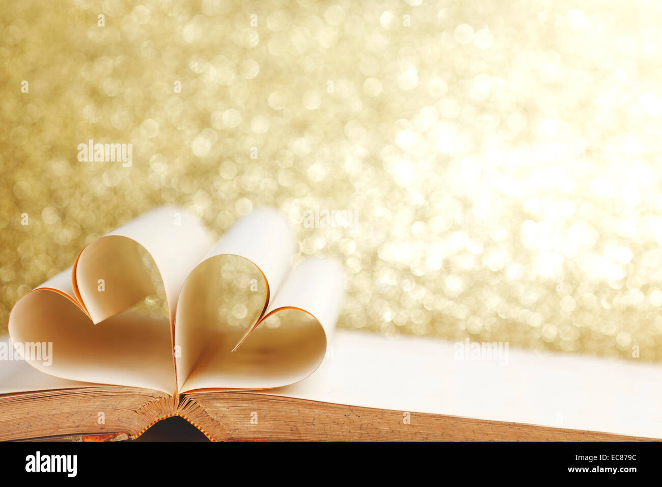 Heart made of blank pages inside a book on glitter background Stock ...