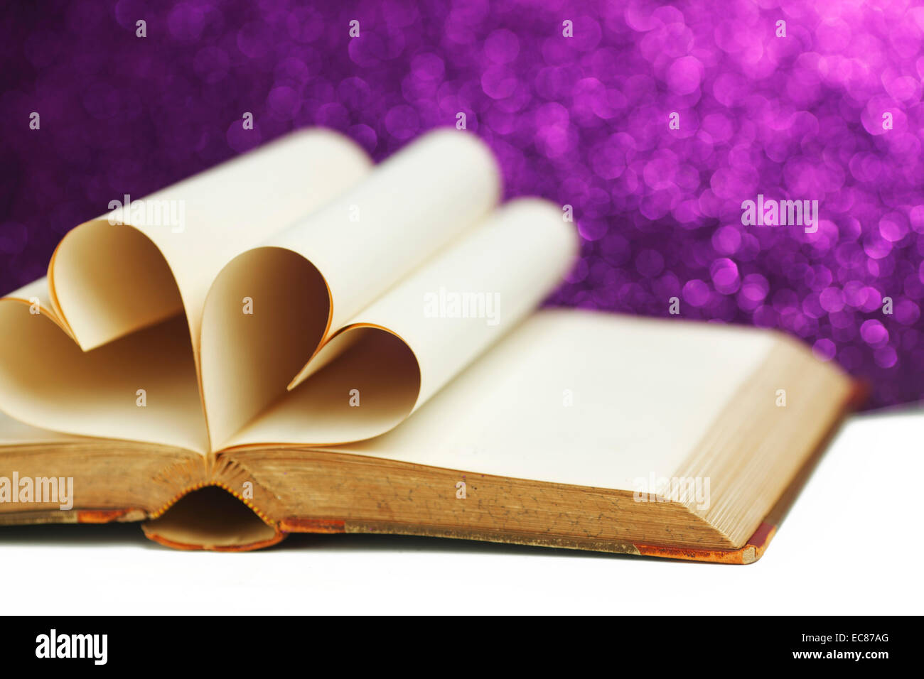 Heart made of blank pages inside a book on glitter background Stock ...